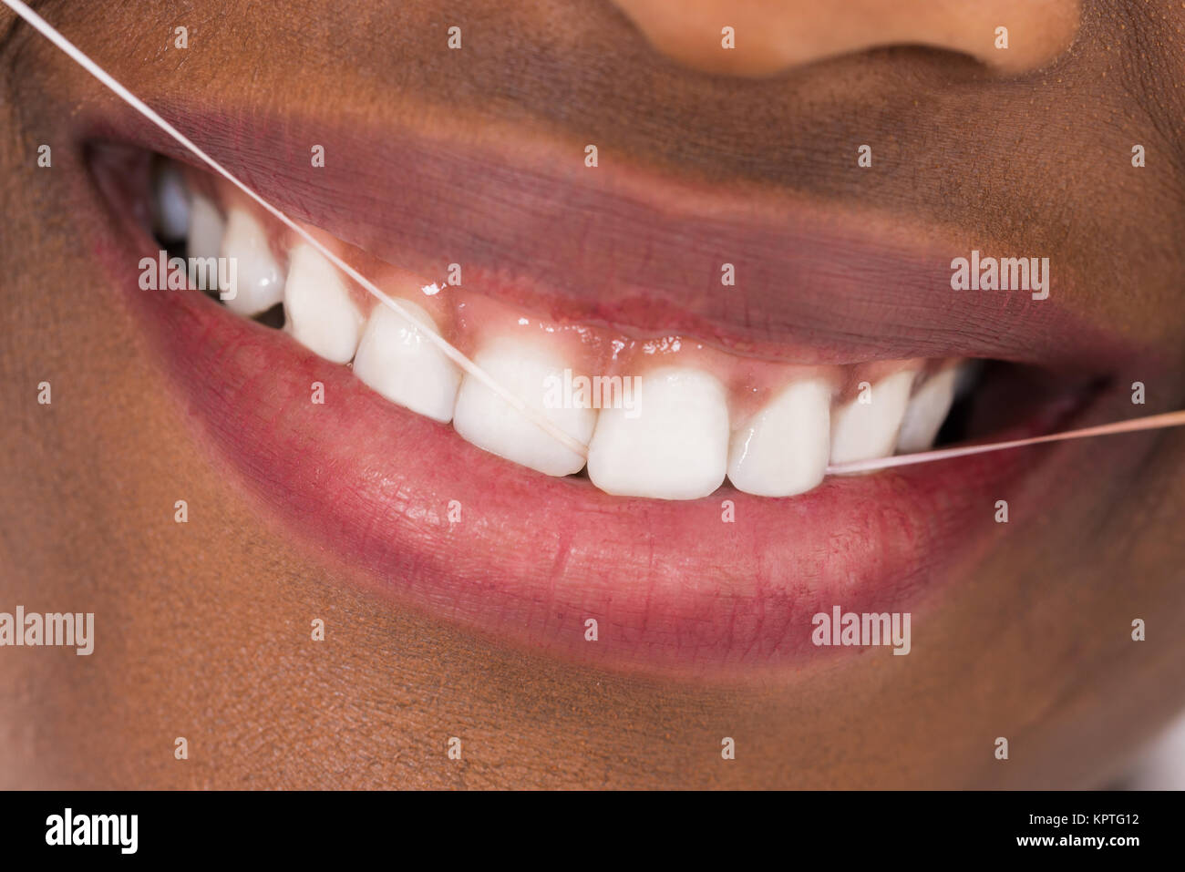 African Woman Flossing Teeth Stock Photo - Alamy