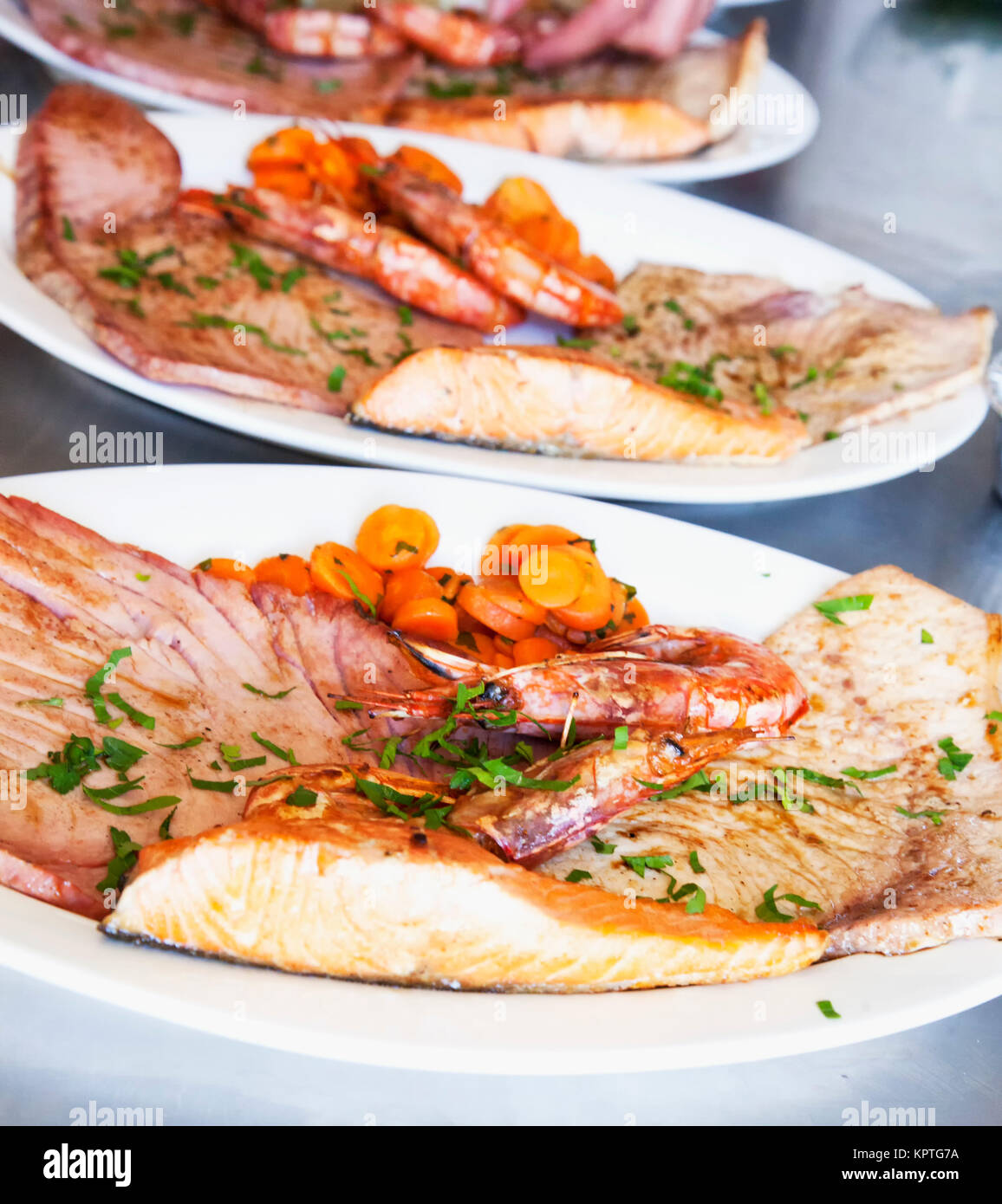 Fish over plates Stock Photo - Alamy