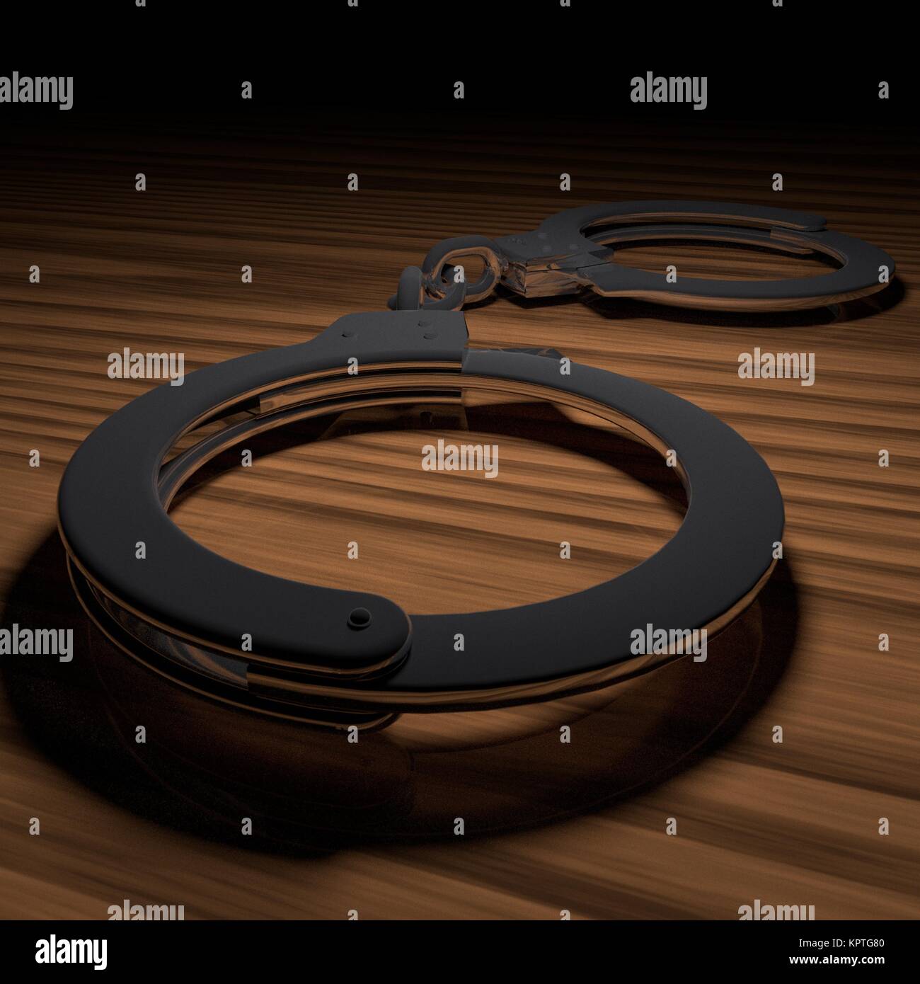 Metal handcuffs over wooden table Stock Photo - Alamy