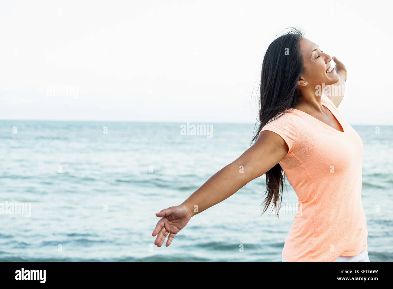 Asian woman with open arms Stock Photo - Alamy