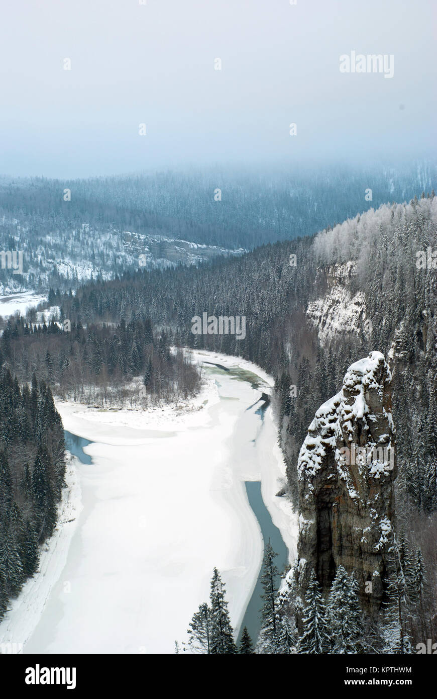 Winter view of the rock Devil`s Finger and the river Usva from the rock ...