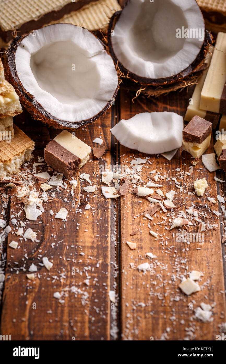 Broken coconut with sweets Stock Photo - Alamy