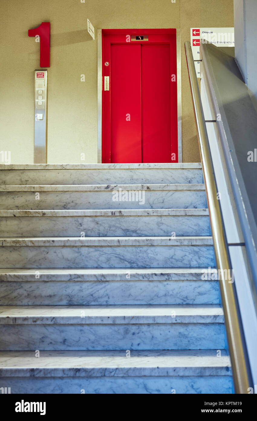 hospital stairs waiting hallway red elevator Stock Photo - Alamy