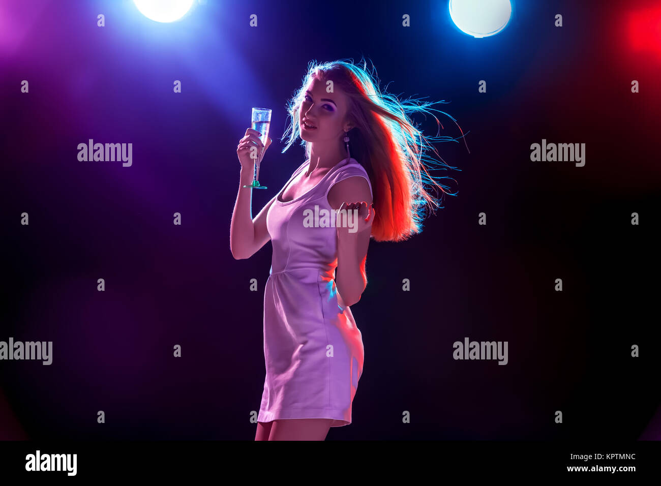 The beautiful girl dancing at the party drinking champagne Stock Photo ...