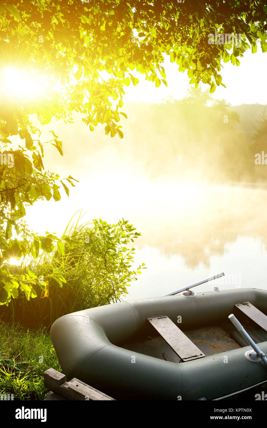Boat on river bank Stock Photo - Alamy