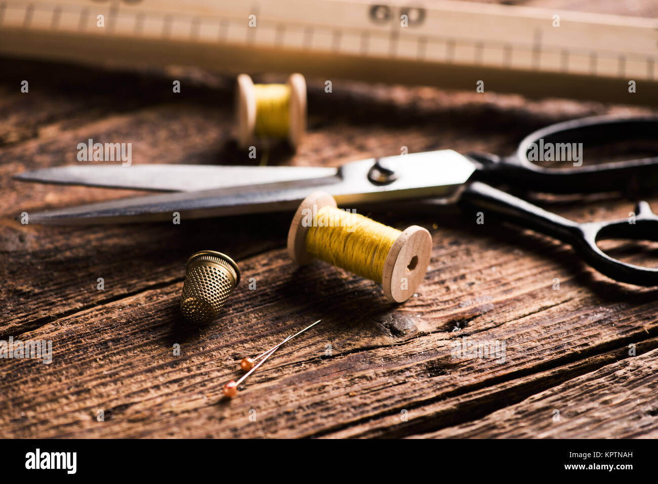 Sewing tools on wooden table Stock Photo - Alamy