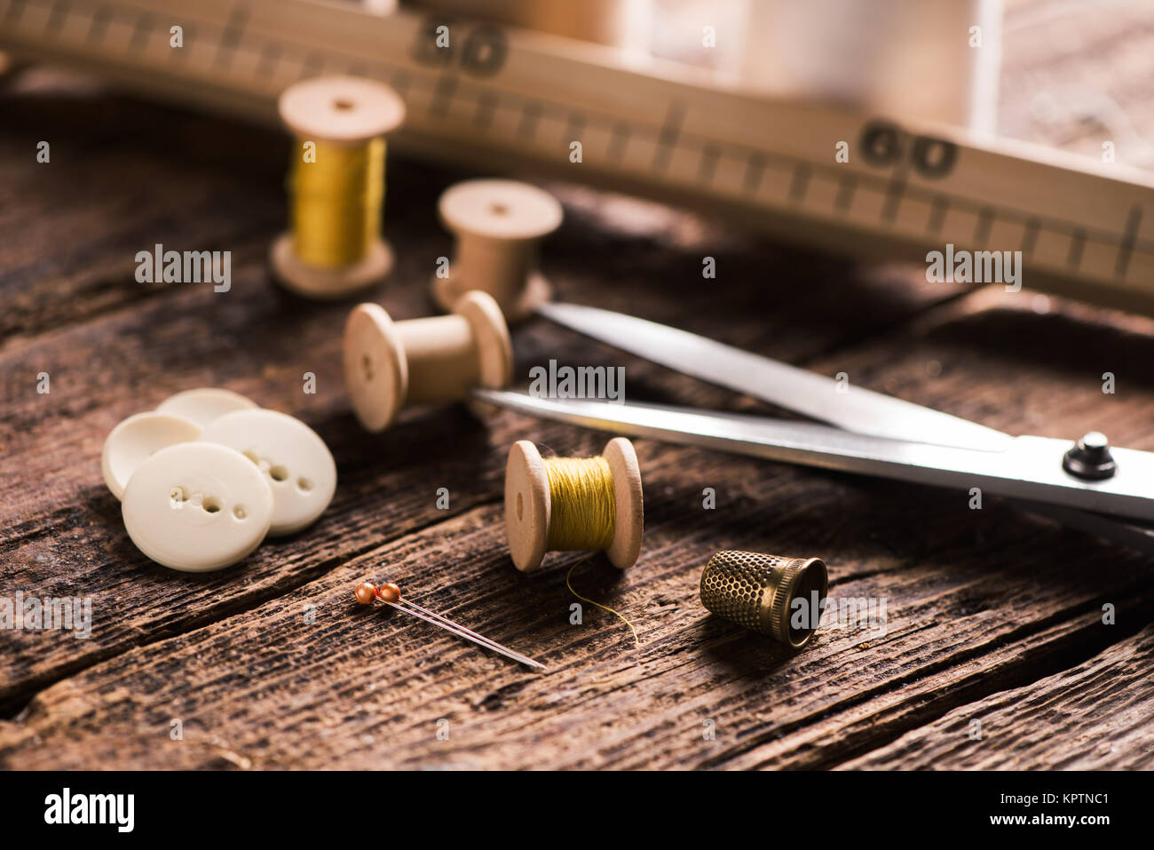 Sewing tools on wooden table Stock Photo - Alamy