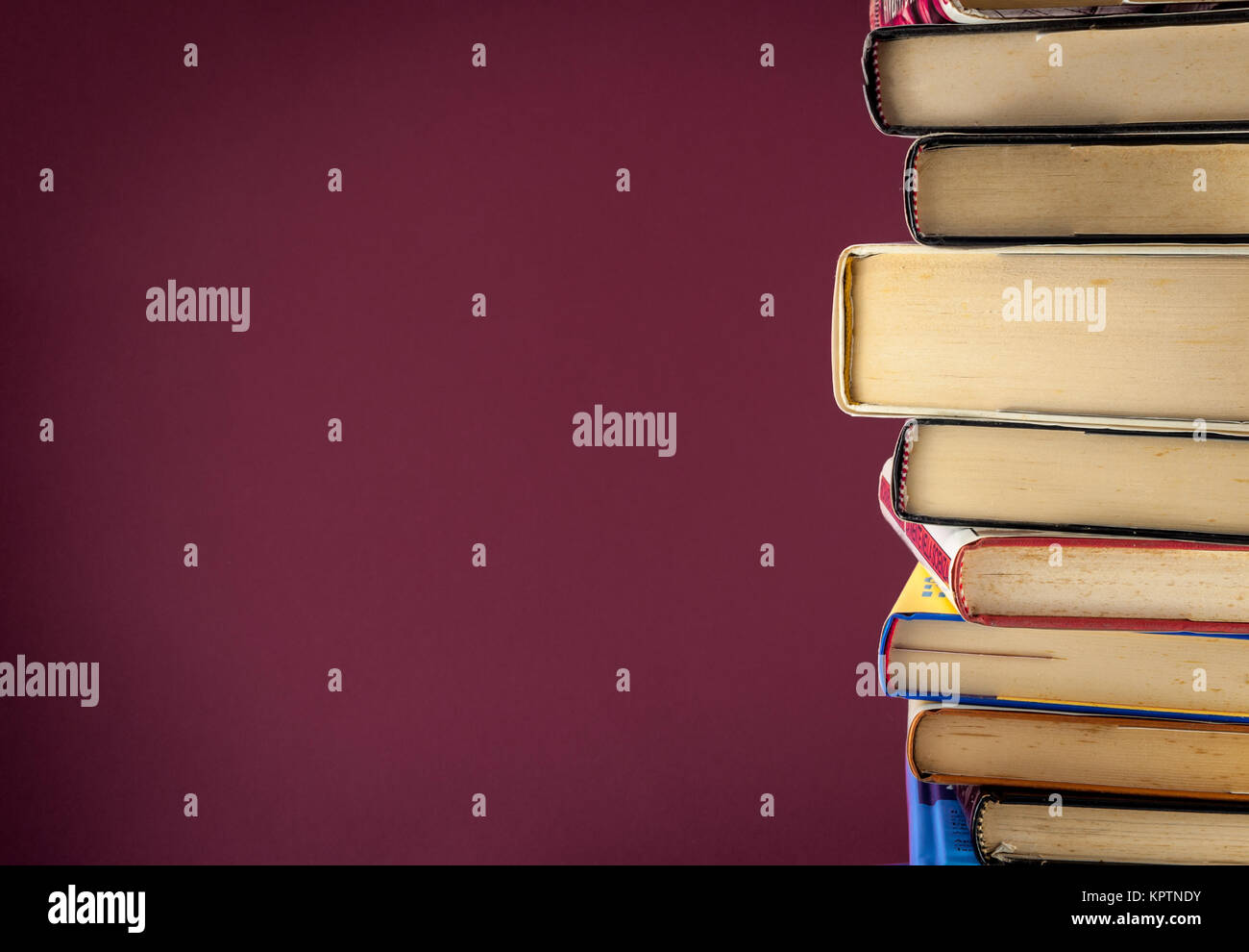 A pile of books on colored background Stock Photo - Alamy
