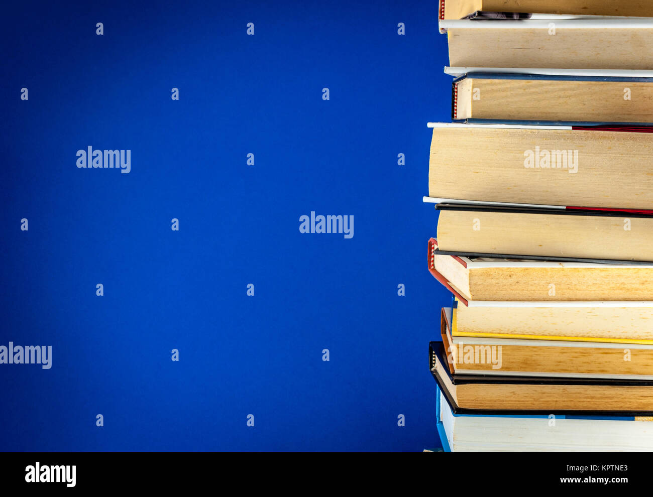 A pile of books on colored background Stock Photo - Alamy