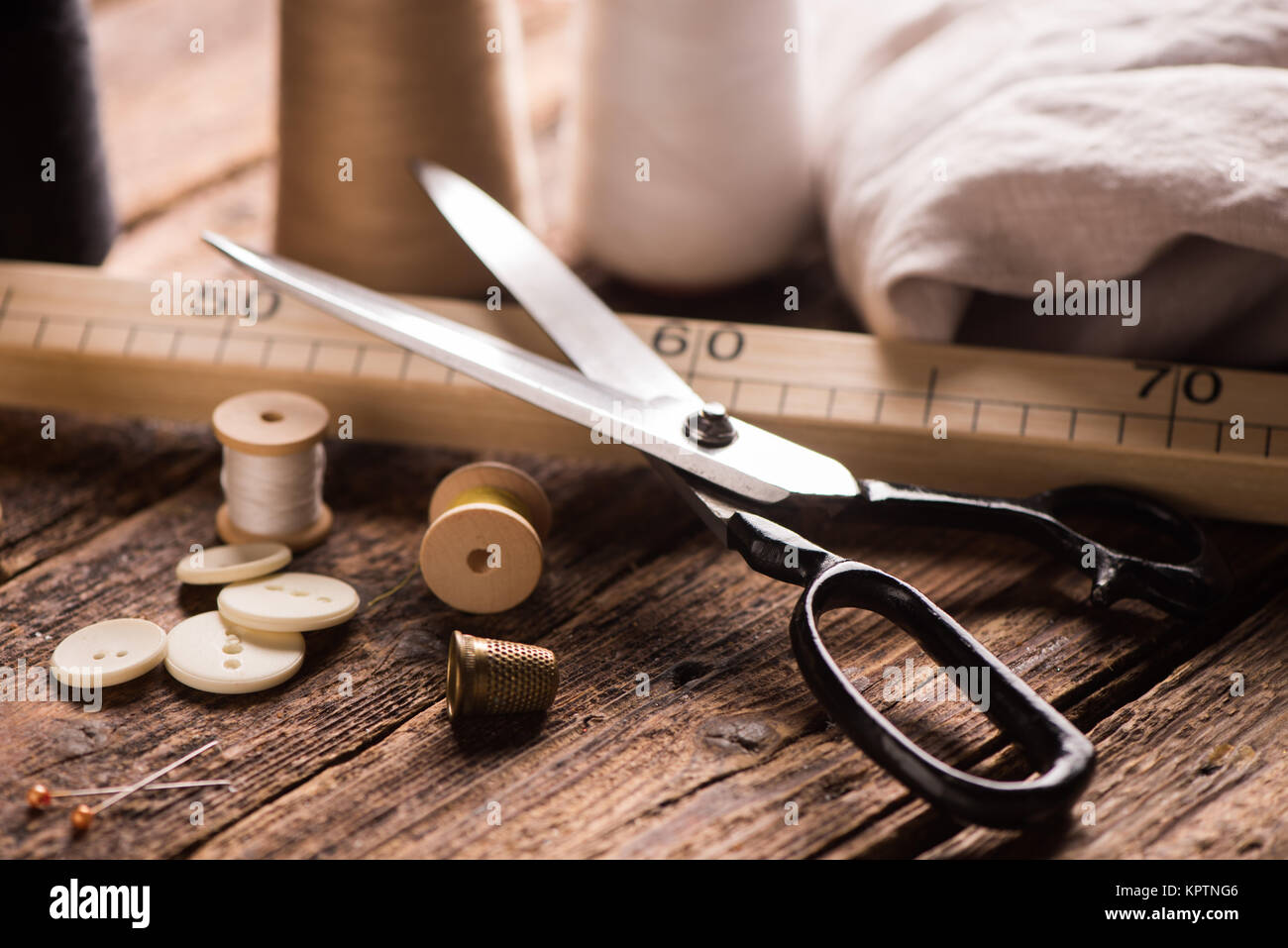 Sewing tools on wooden table Stock Photo - Alamy
