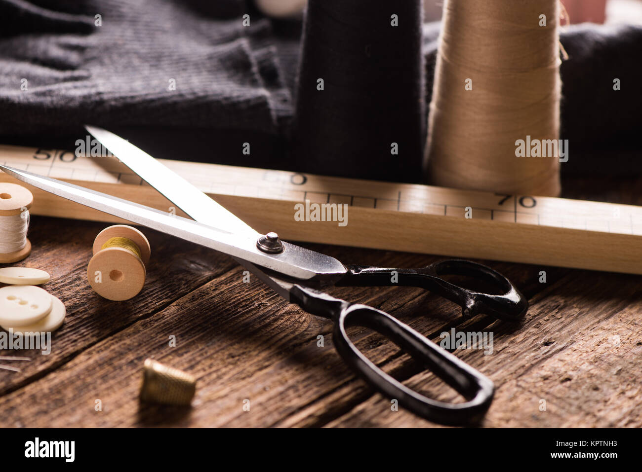 Sewing tools on wooden table Stock Photo - Alamy