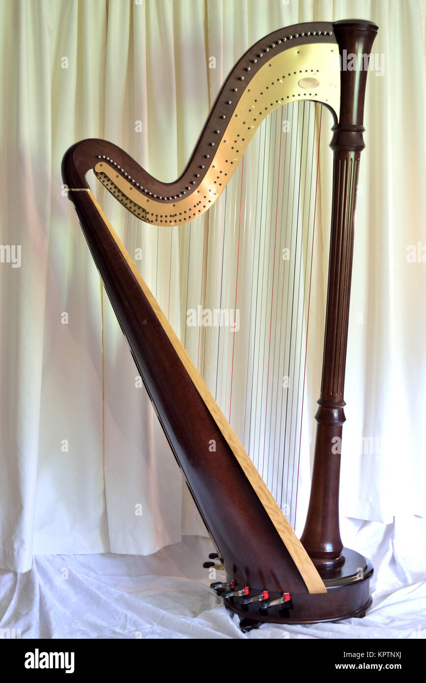 Dark wood concert grand pedal harp against wide curtains Stock Photo ...