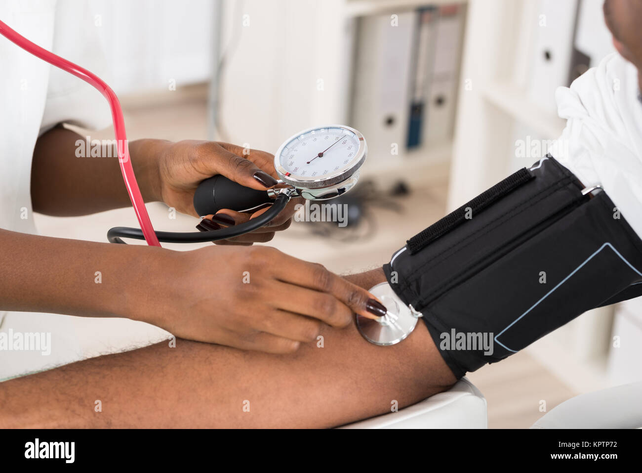 Close-up Of Doctor Measuring Patients Blood Pressure With Stethoscope ...