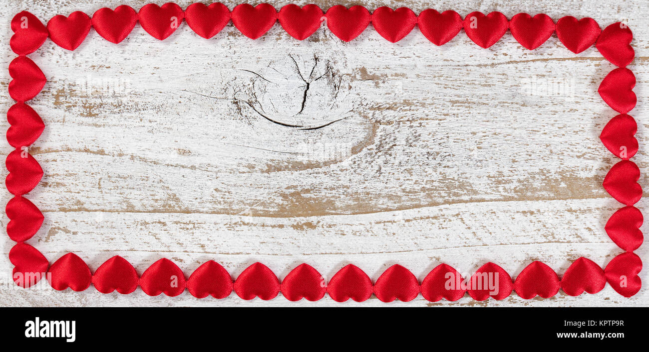 Red hearts in complete border on rustic white wood in flat lay view ...