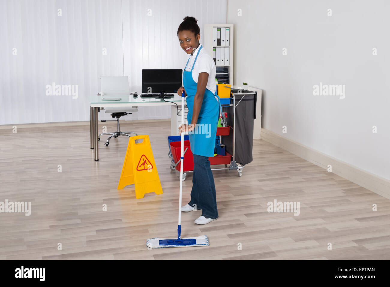 Female janitor cleaning wooden hi-res stock photography and images - Alamy