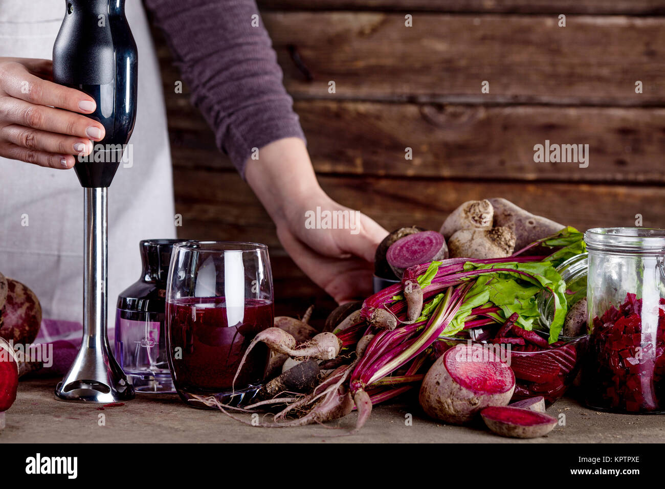 Cook is making a beetroot juice with blender Stock Photo - Alamy