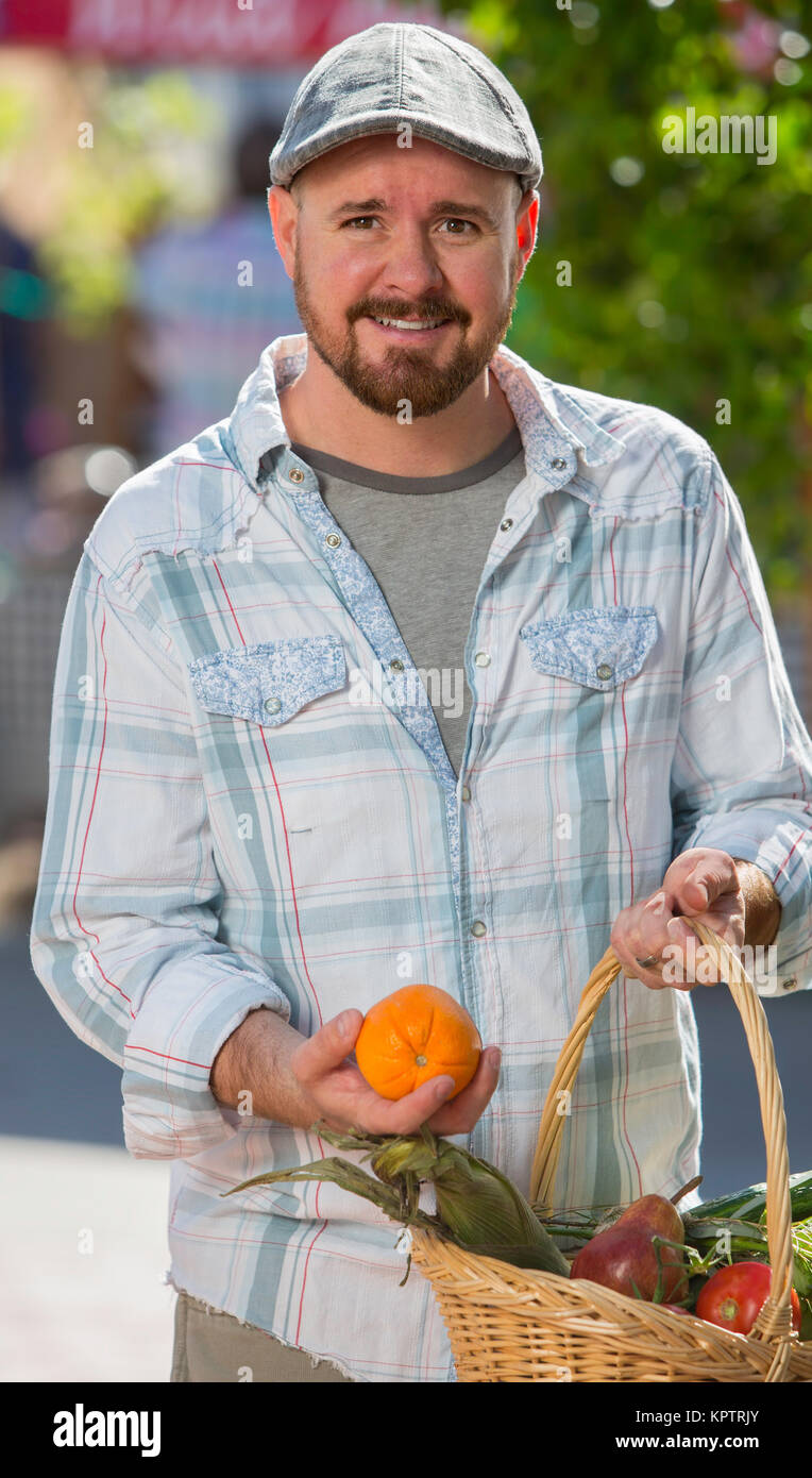 Man with basket of produce at farmers market Stock Photo - Alamy