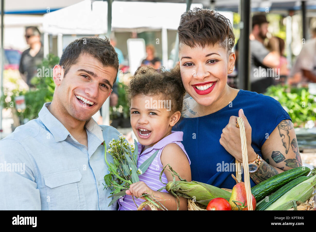 Smiling family with basket of produce at farmers market Stock Photo - Alamy