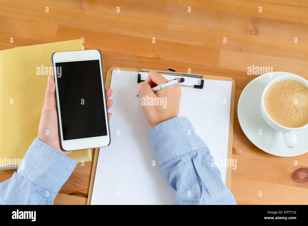 Woman writing on clipboard Stock Photo - Alamy