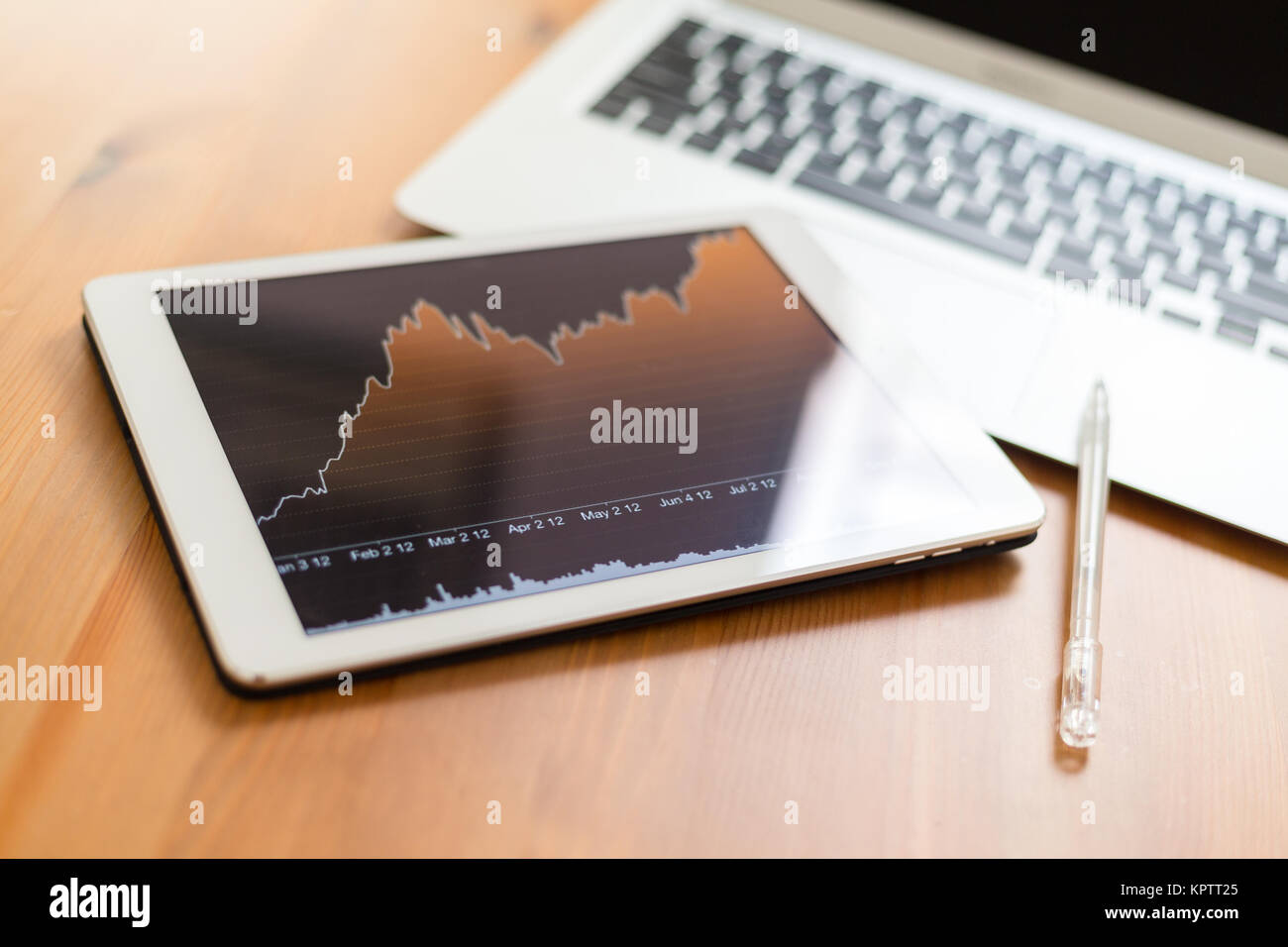 Tablet computer and financial charts Stock Photo - Alamy