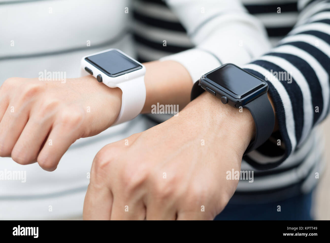 Couple connecting smart watch together at outdoor Stock Photo - Alamy