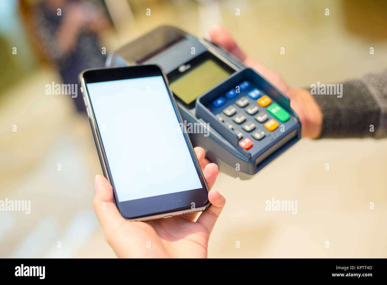 Customer pay with cellphone Stock Photo - Alamy