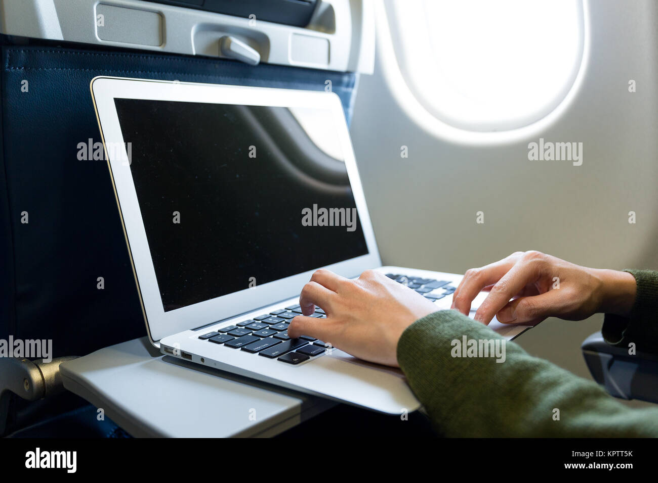 Woman use of laptop computer at airplane Stock Photo - Alamy