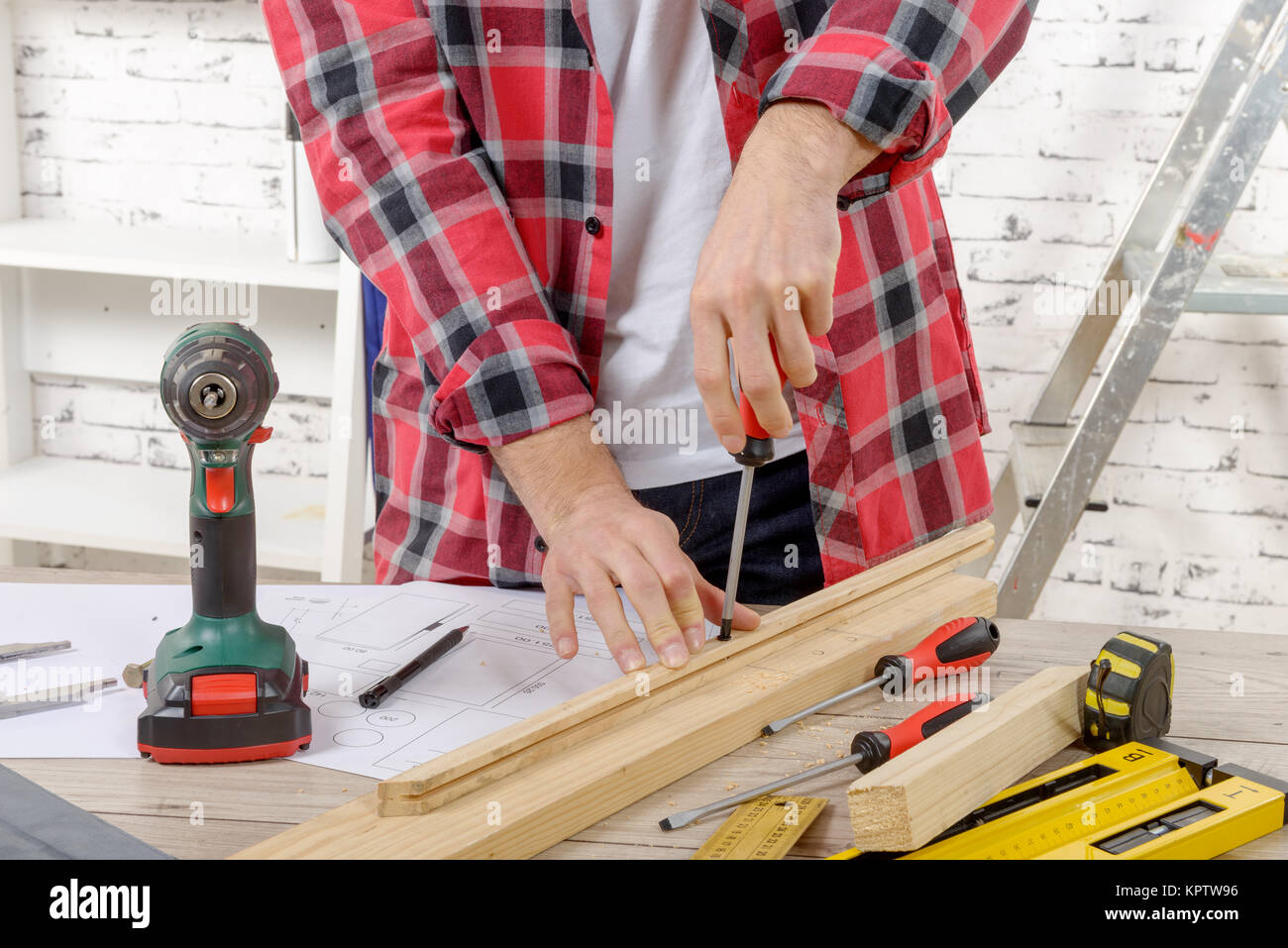a close up of a carpenter screwed on a wooden plank Stock Photo - Alamy
