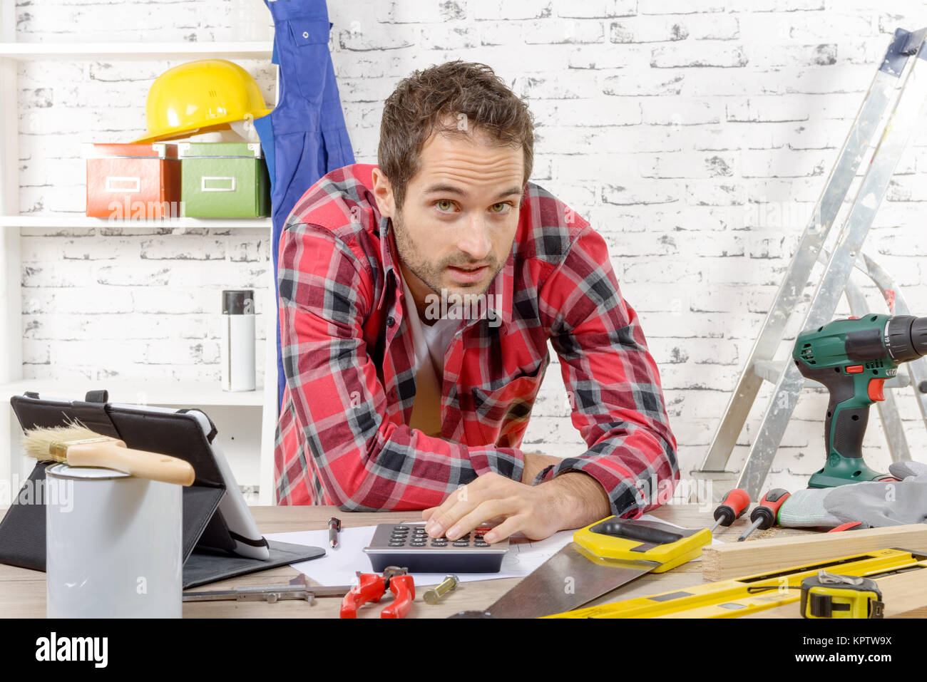 a smiling young carpenter in his workshop Stock Photo - Alamy