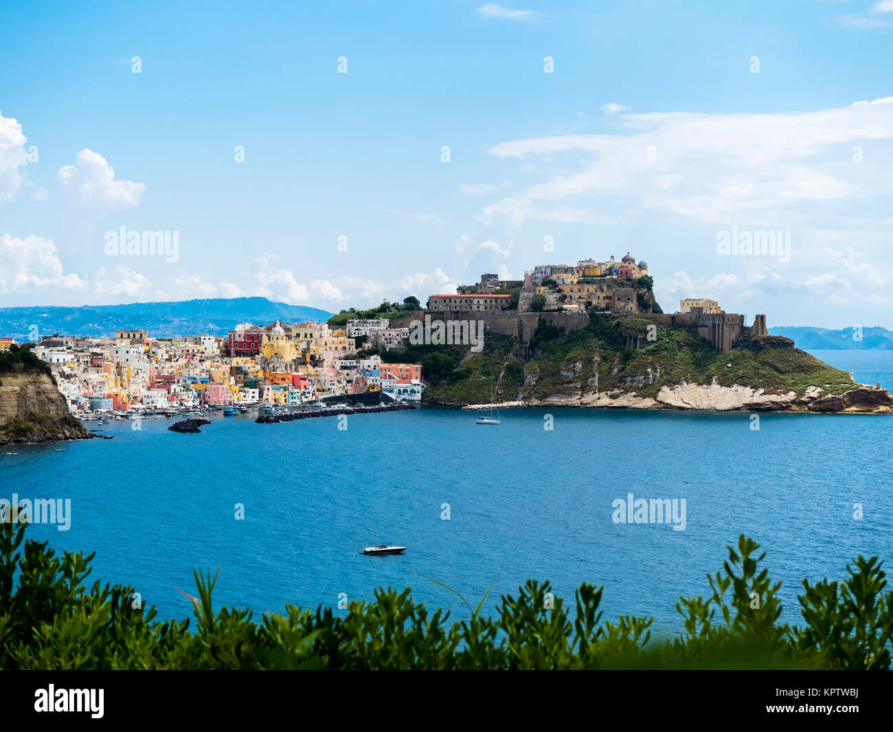 View of the island of Procida with its colourful houses, harbour and ...