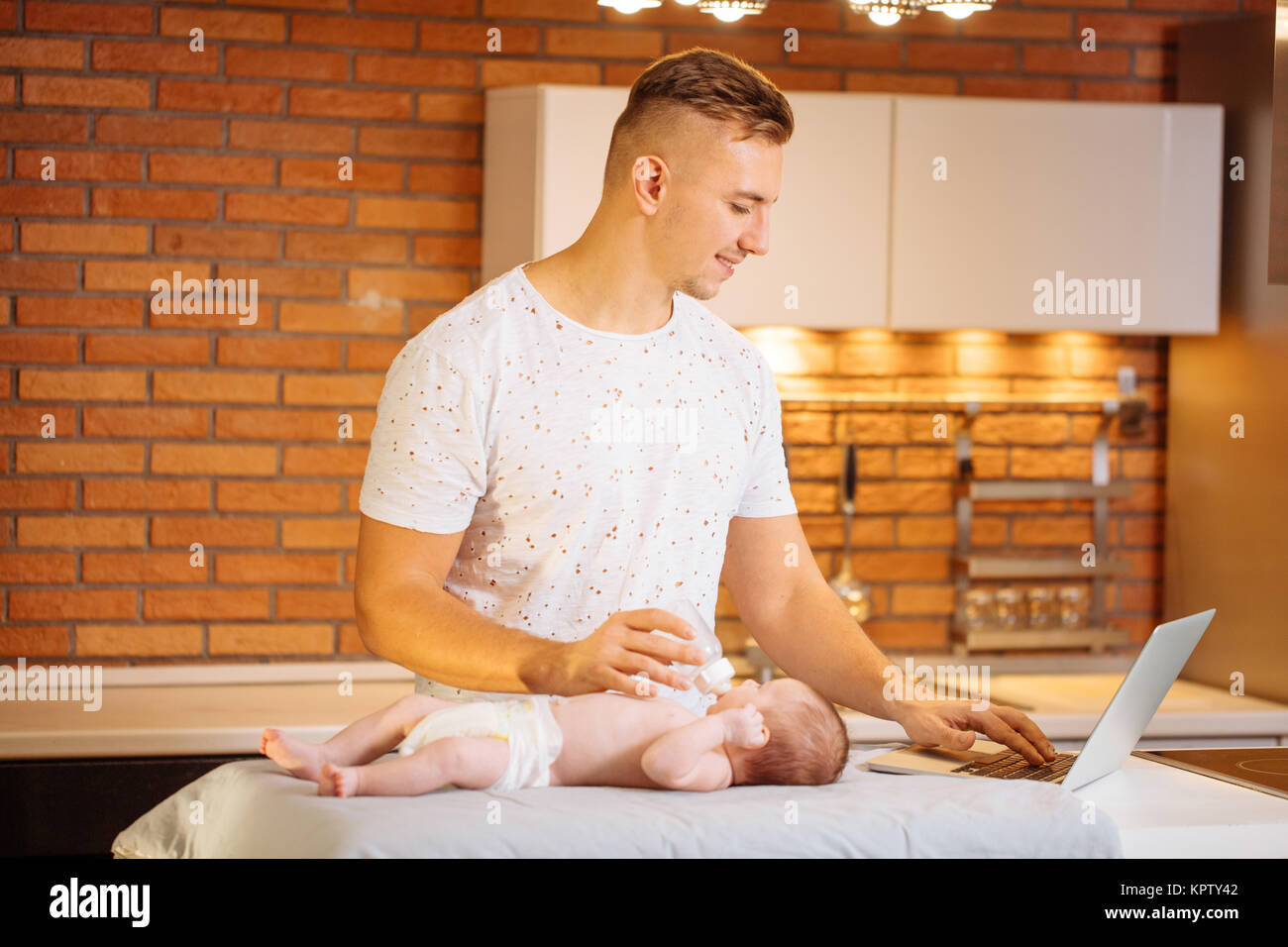 father is changing nappy to his baby boy Stock Photo - Alamy