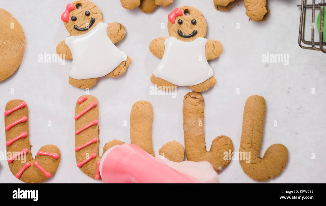 Decorating gingerbread cookies with royal icing for Christmas Stock ...