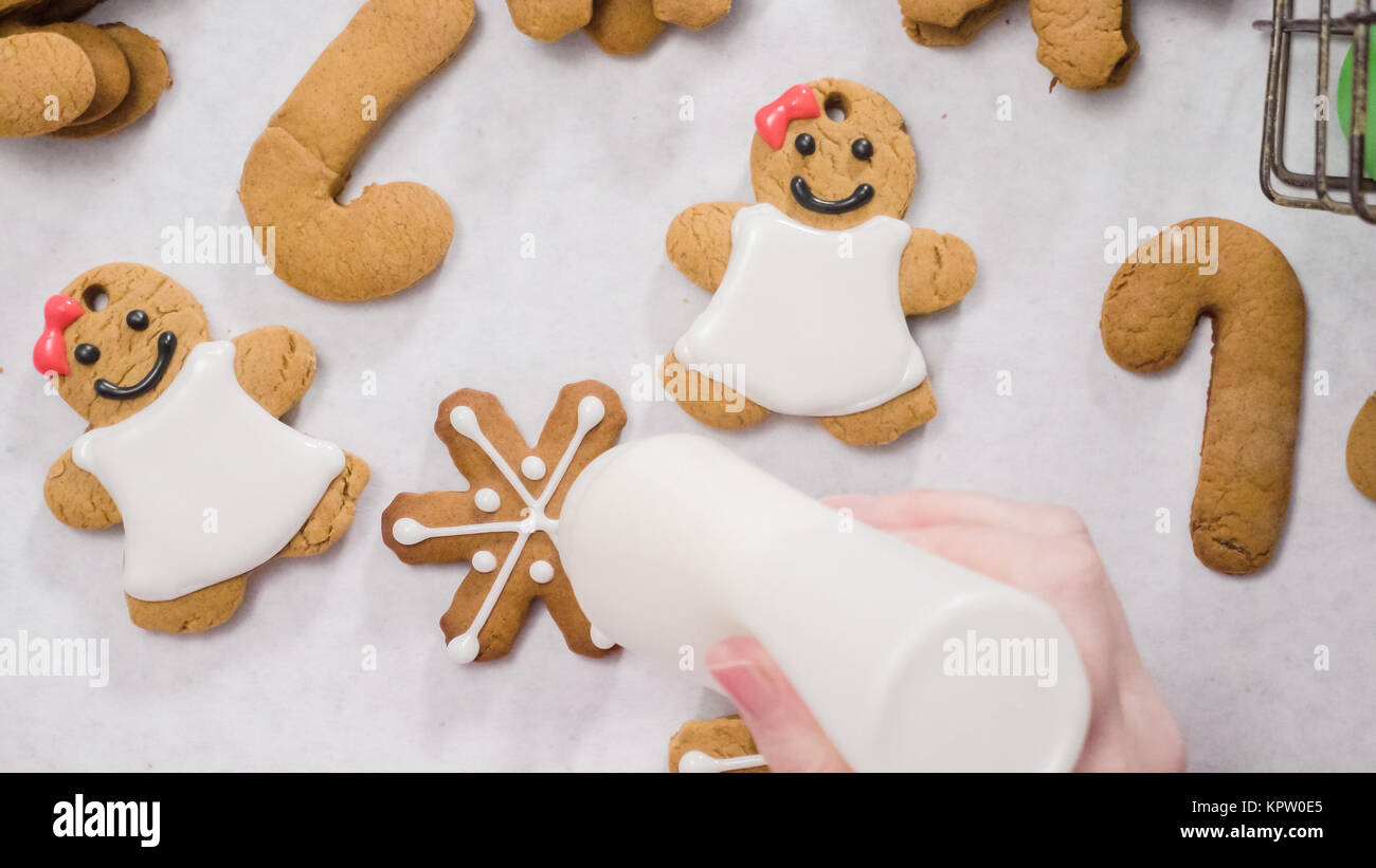 Decorating gingerbread cookies with royal icing for Christmas Stock ...