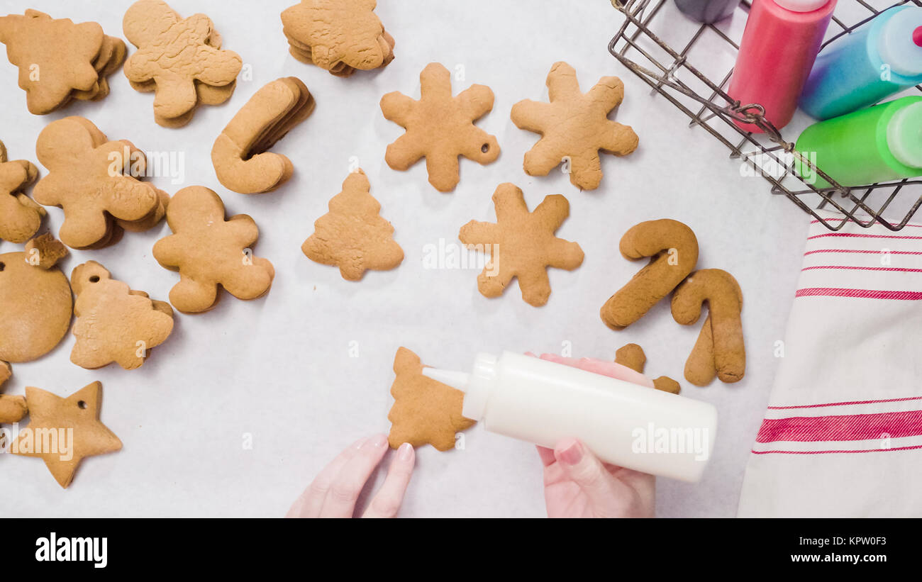 Decorating gingerbread cookies with royal icing for Christmas Stock ...