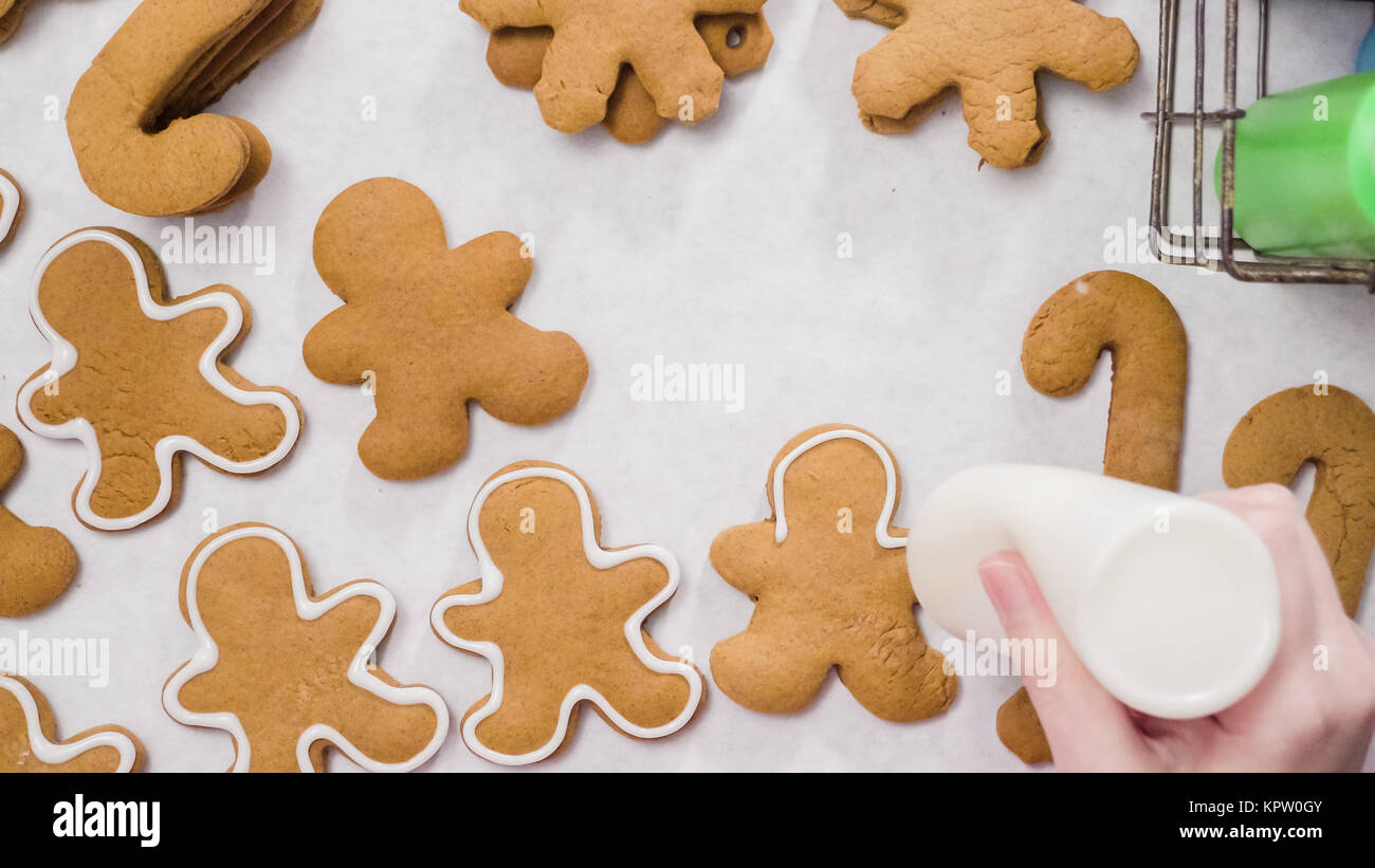 Decorating gingerbread cookies with royal icing for Christmas Stock ...