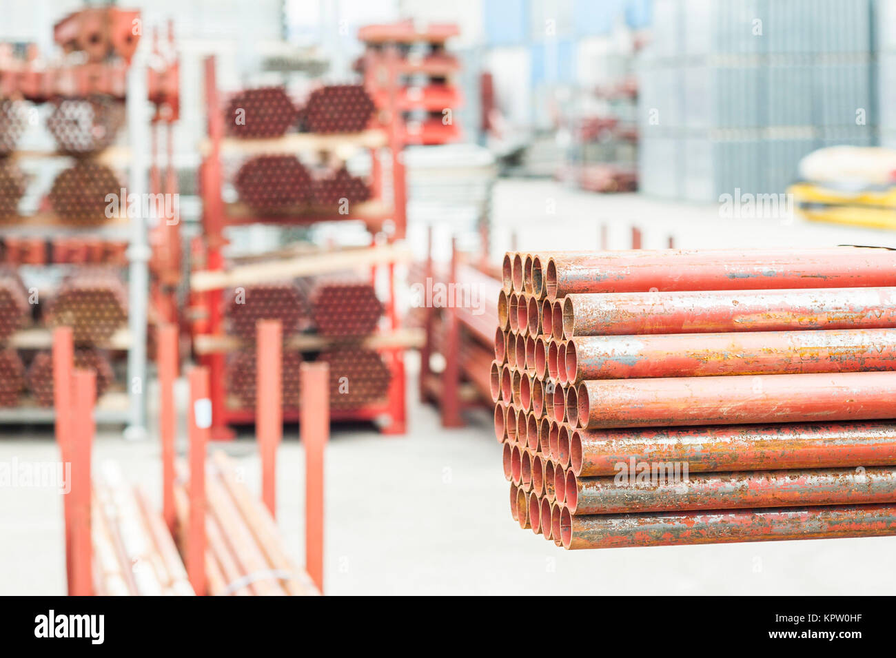 Stack of steel pipes for scaffolding in warehouse Stock Photo - Alamy
