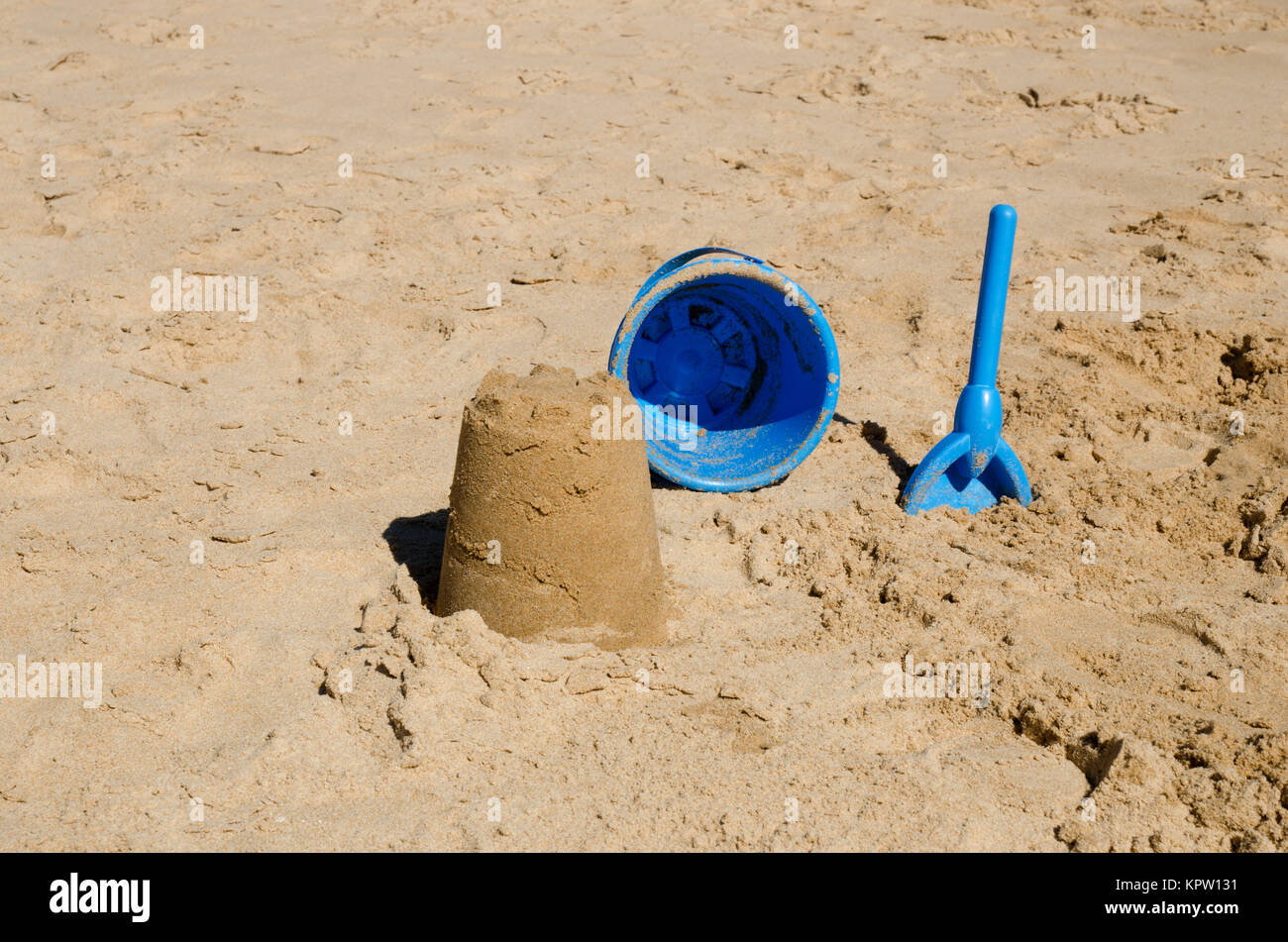 Sandcastle, bucket and spade on beach Stock Photo - Alamy