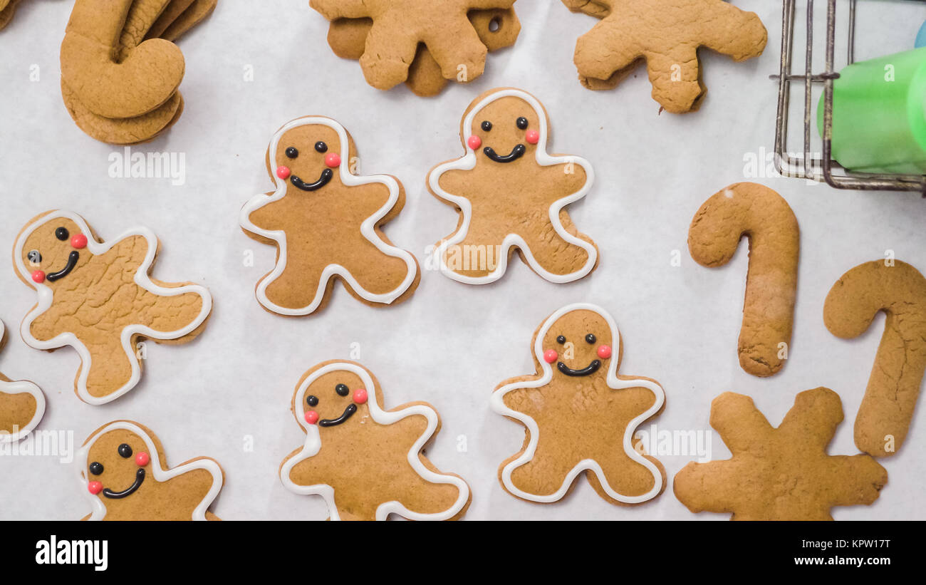 Decorating gingerbread cookies with royal icing for Christmas Stock ...