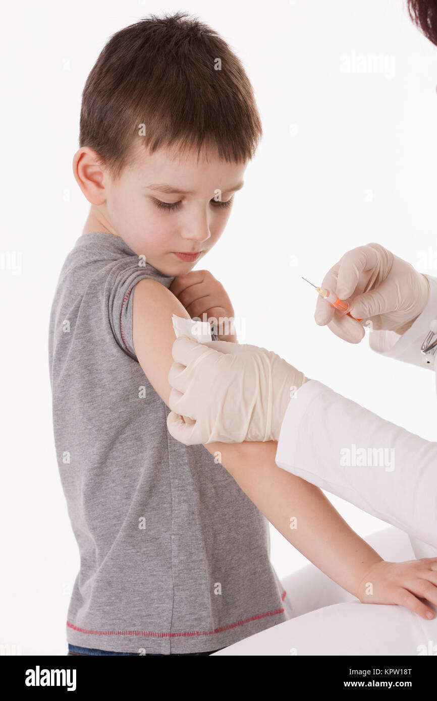 Doctor giving a child injection in arm on isolated image Stock Photo ...