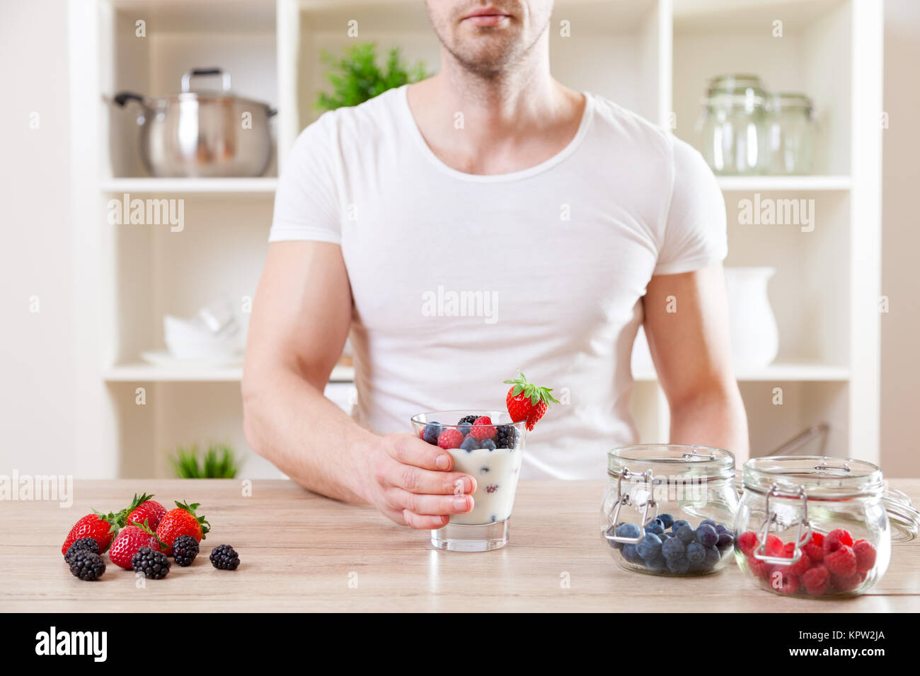 Man with delicious yogurt with fresh berries Stock Photo - Alamy