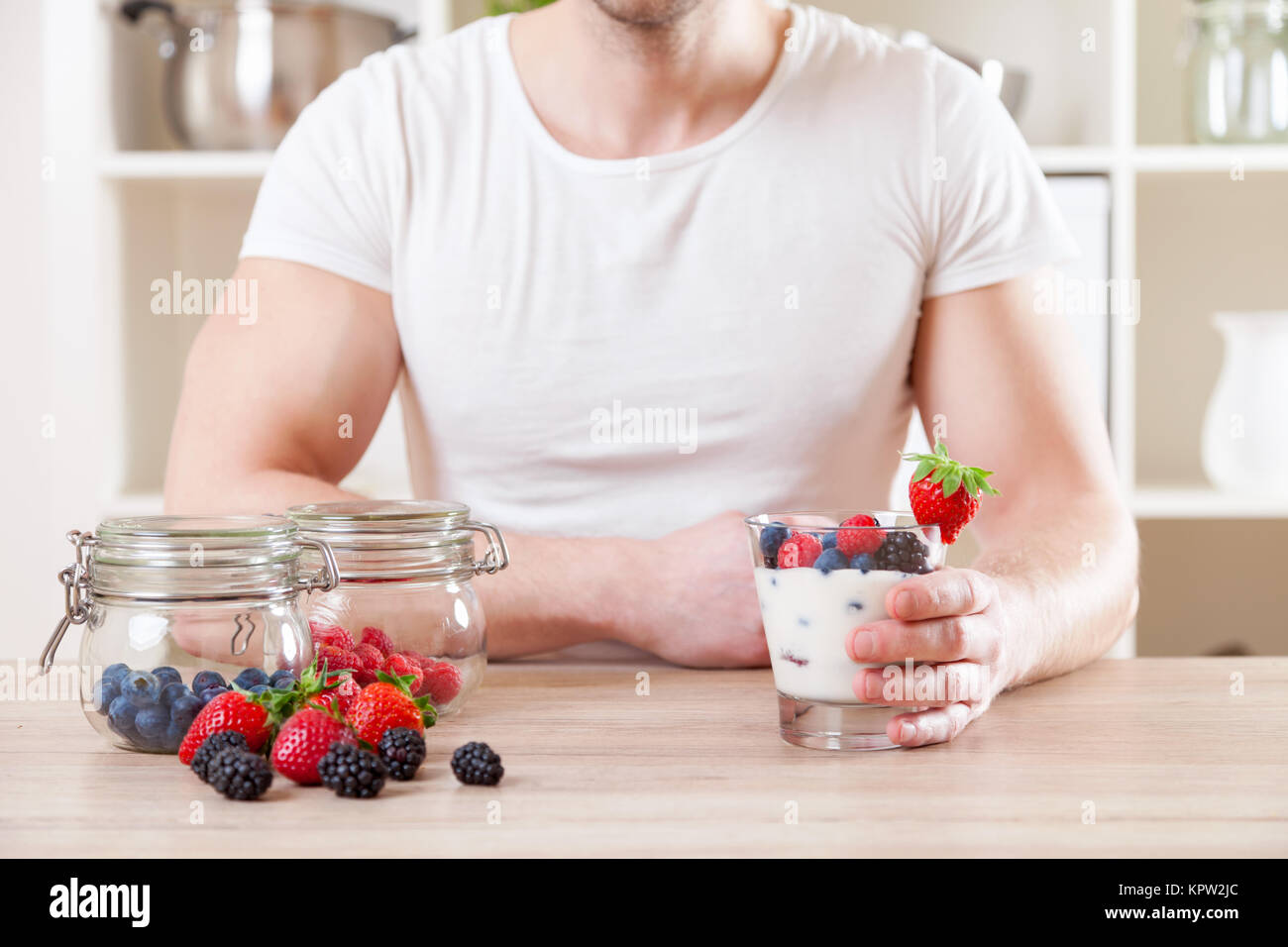 Man with delicious yogurt with fresh berries Stock Photo - Alamy