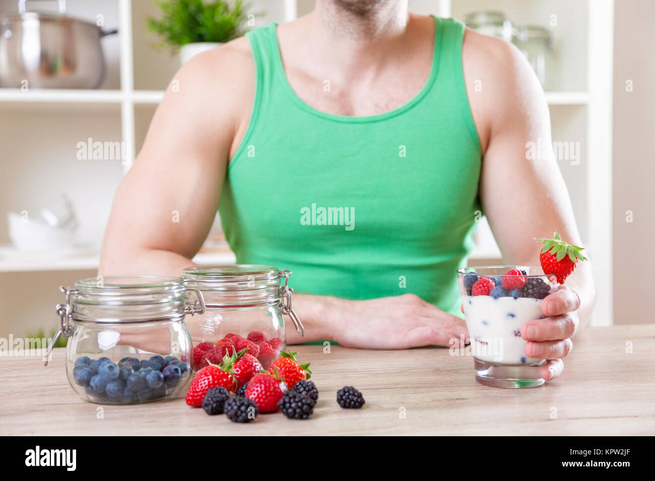 Man with delicious yogurt with fresh berries Stock Photo - Alamy