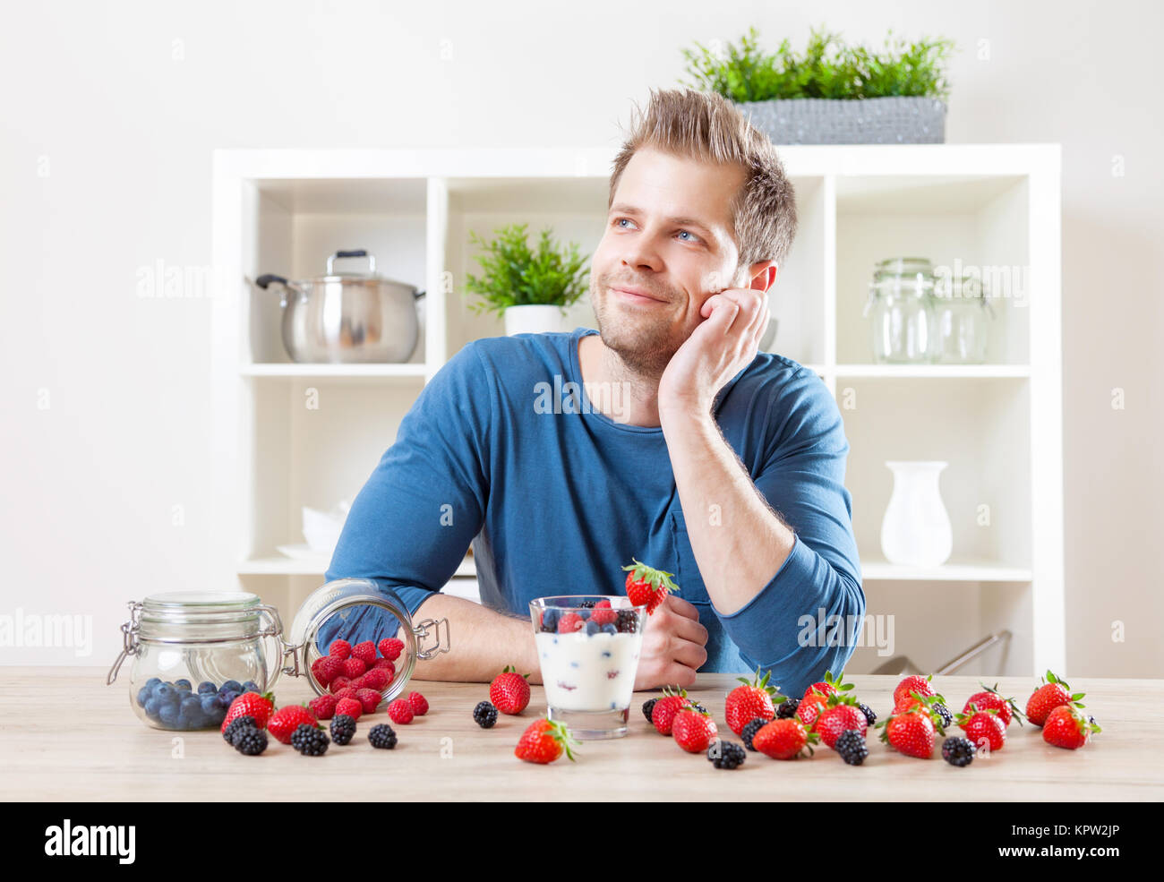 Man with delicious yogurt with fresh berries Stock Photo - Alamy