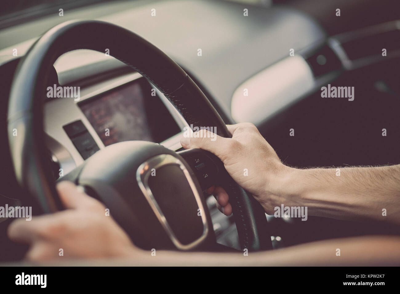 Hands on steering wheel Stock Photo - Alamy