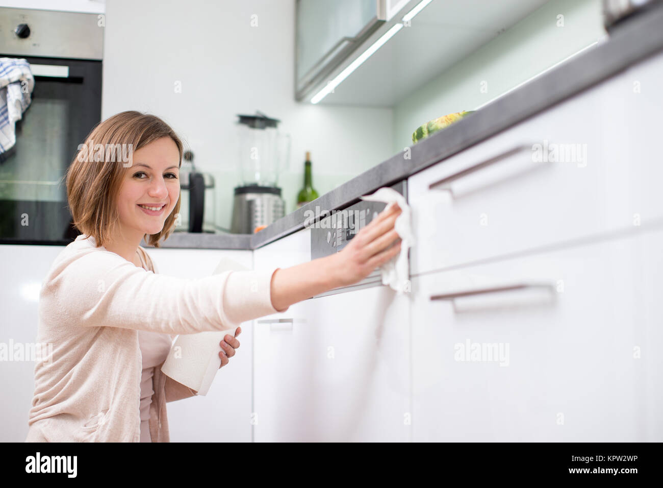 Young woman doing housework, cleaning the kitchen Stock Photo - Alamy