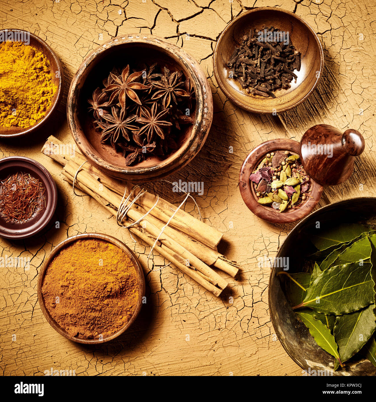 Top down view on pots of assorted whole leaf and ground herbs and ...