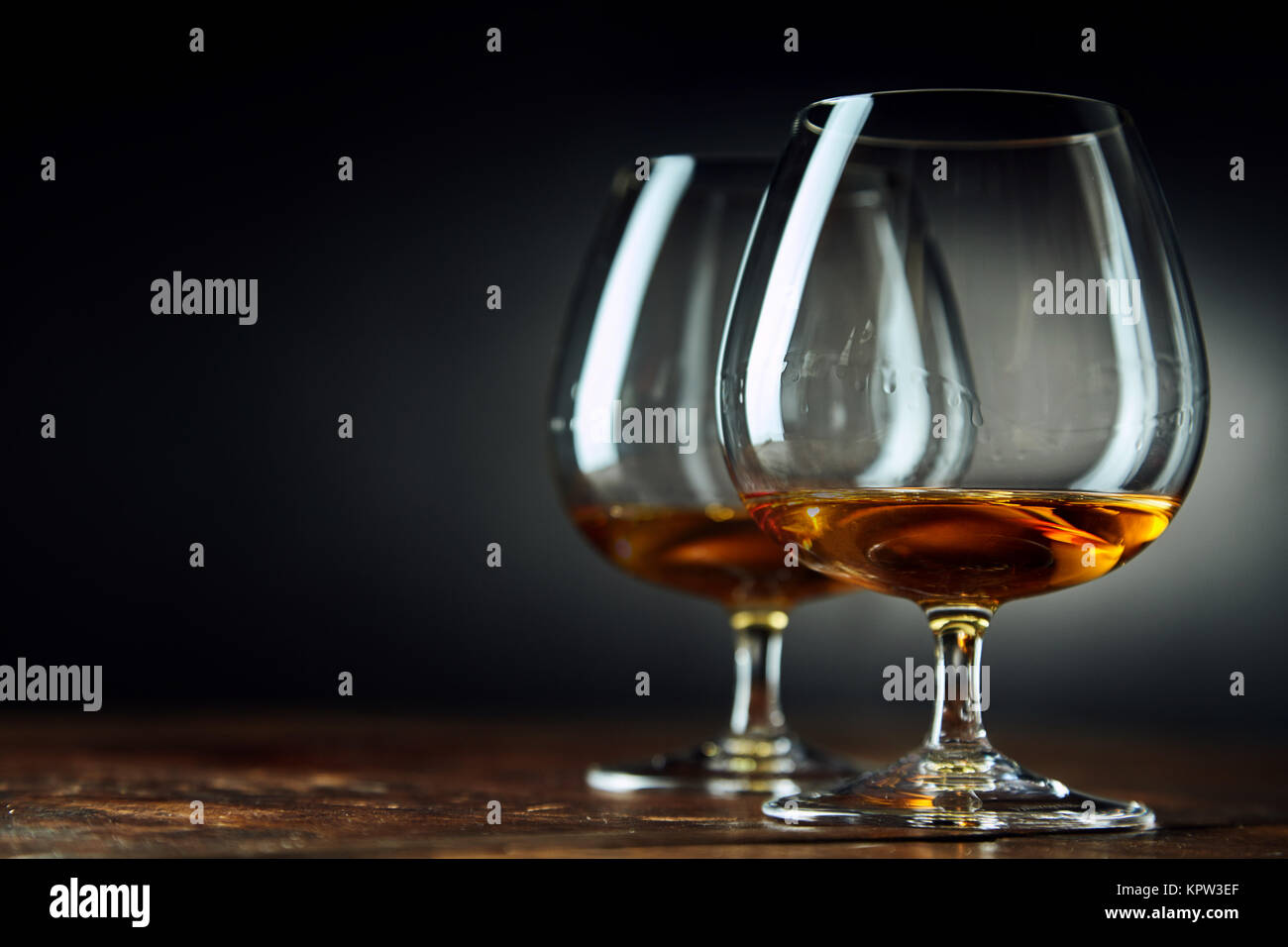 Classic background composed of two goblets filled with bourbon sitting ...