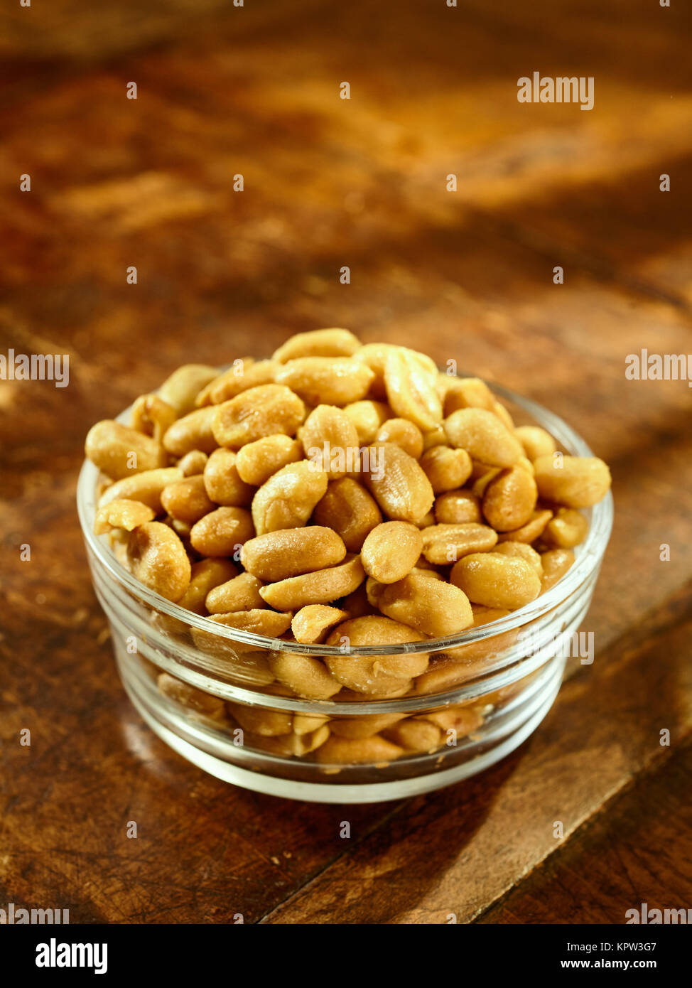 Glass bowl of roasted peanuts or groundnuts for nutritious snacks on a ...