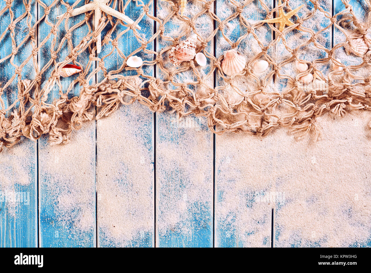 Nautical Themed Background with Copy Space - Fishing Net with Seashells and Sand Scattered on ...