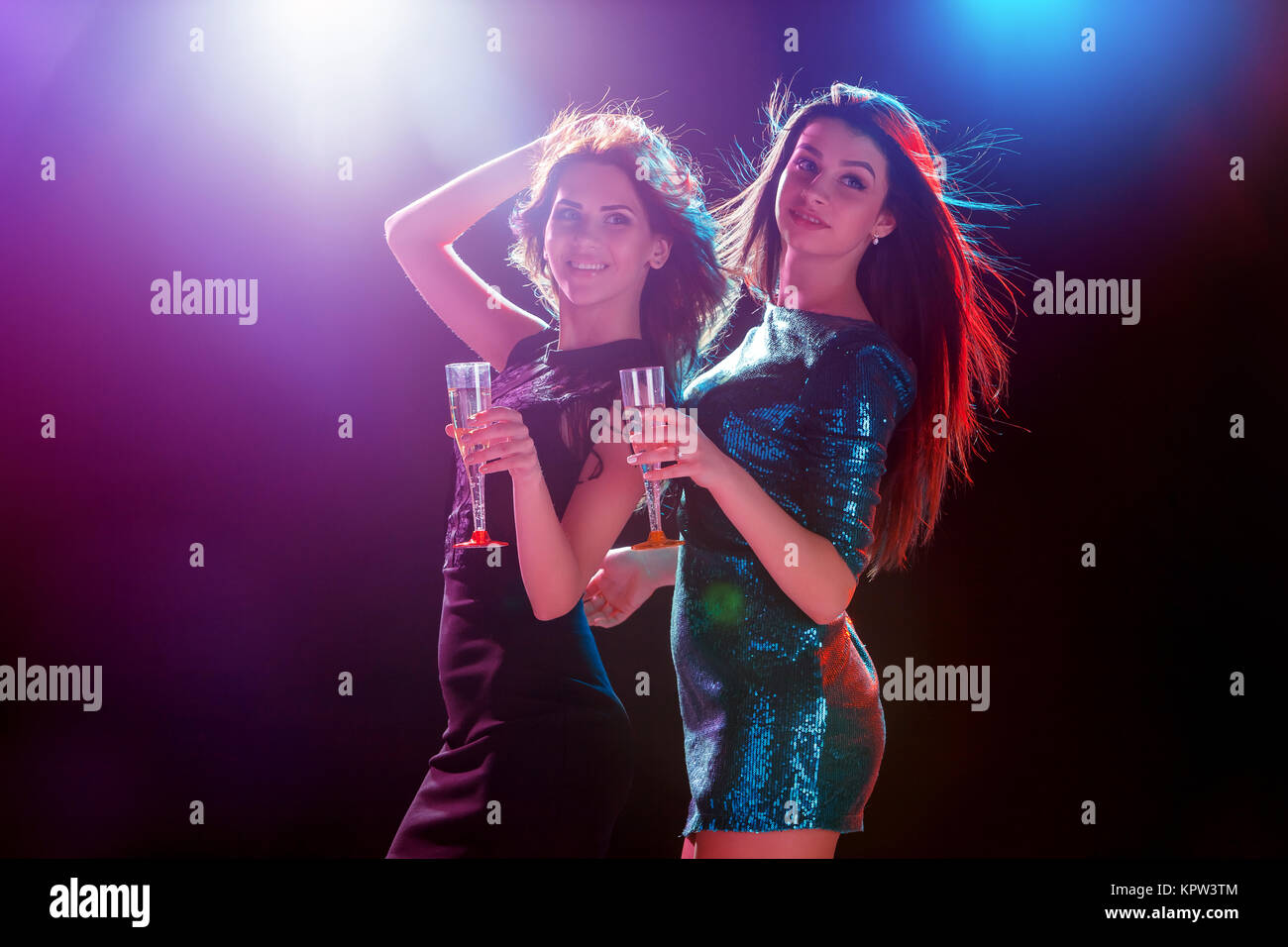 Two beautiful girls dancing at the party drinking champagne Stock Photo ...